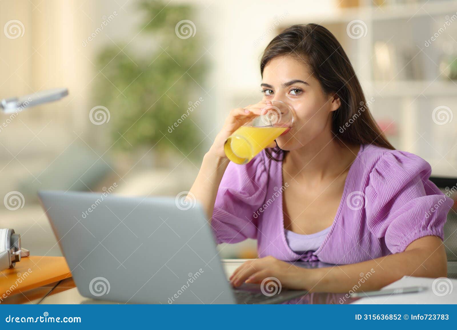 Student Drinking Orange Juice and Looking at Camera Stock Photo - Image ...