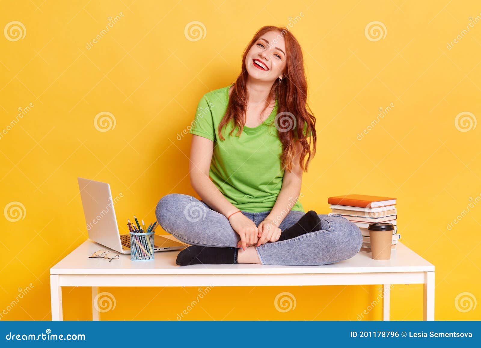 Student Educating while Sitting on Table with Crossed Legs, Studying ...