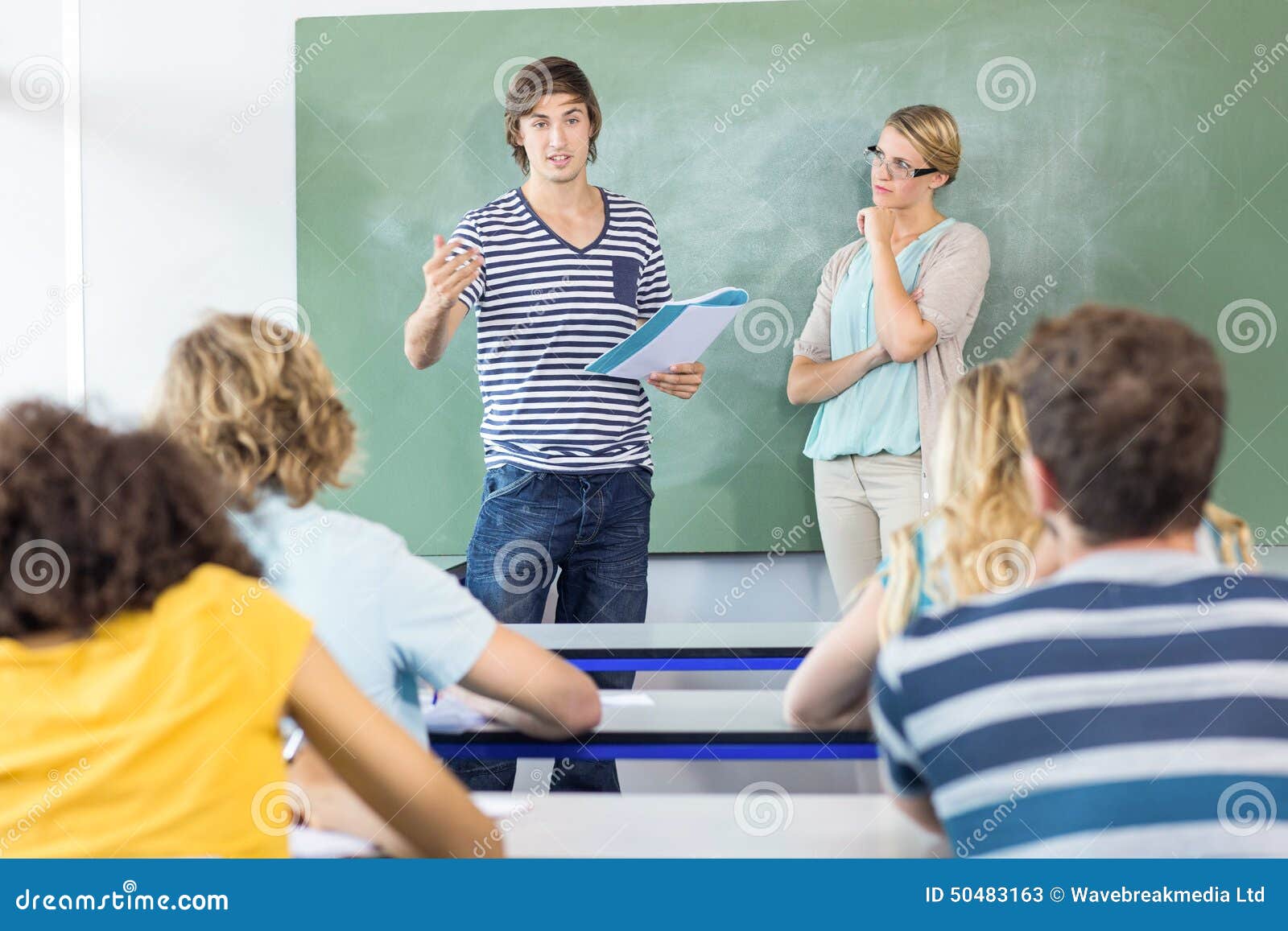 Student Explaining Notes Besides Teacher in Class Stock Image - Image ...