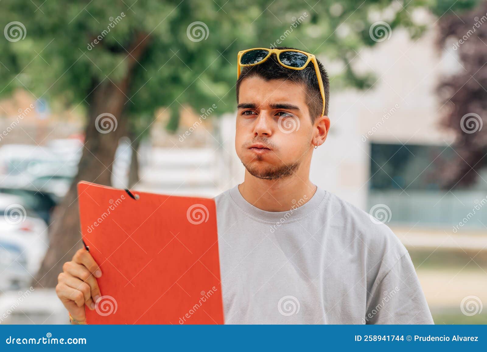 Student fanning himself stock photo. Image of outdoors - 258941744
