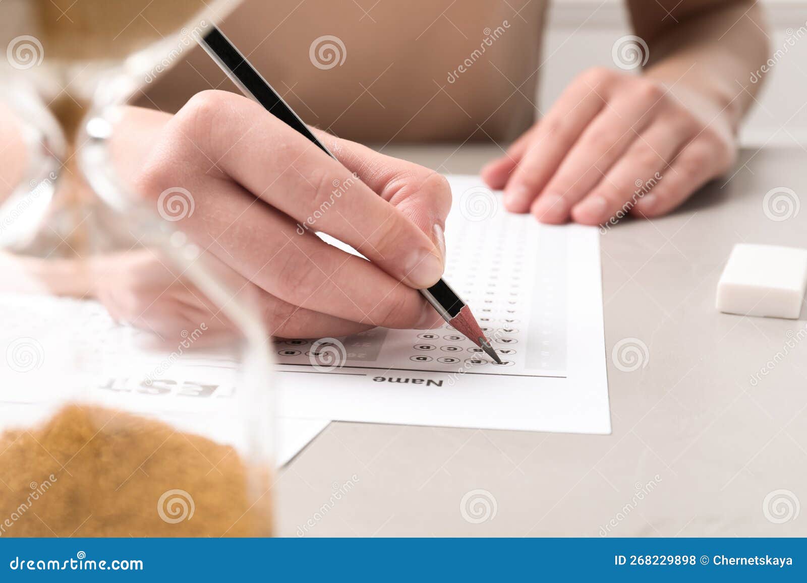 Student Filling Answer Sheet at Light Grey Table, Closeup. Passing Exam ...