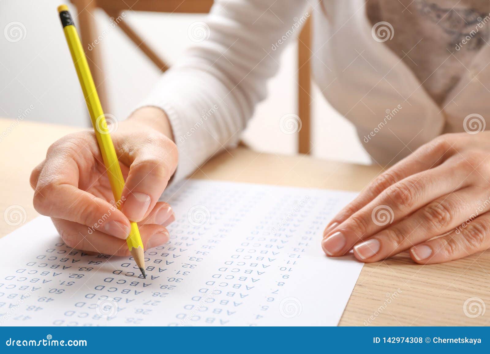 Student Filling Answer Sheet at Table Stock Photo - Image of female ...