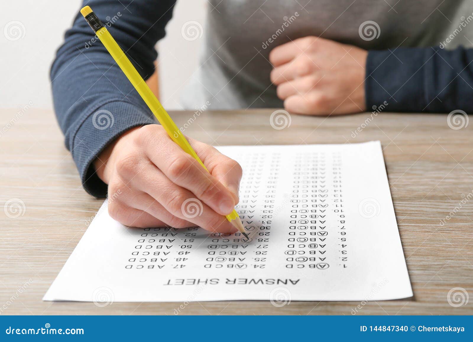 Student Filling Answer Sheet at Table Stock Photo - Image of challenge ...