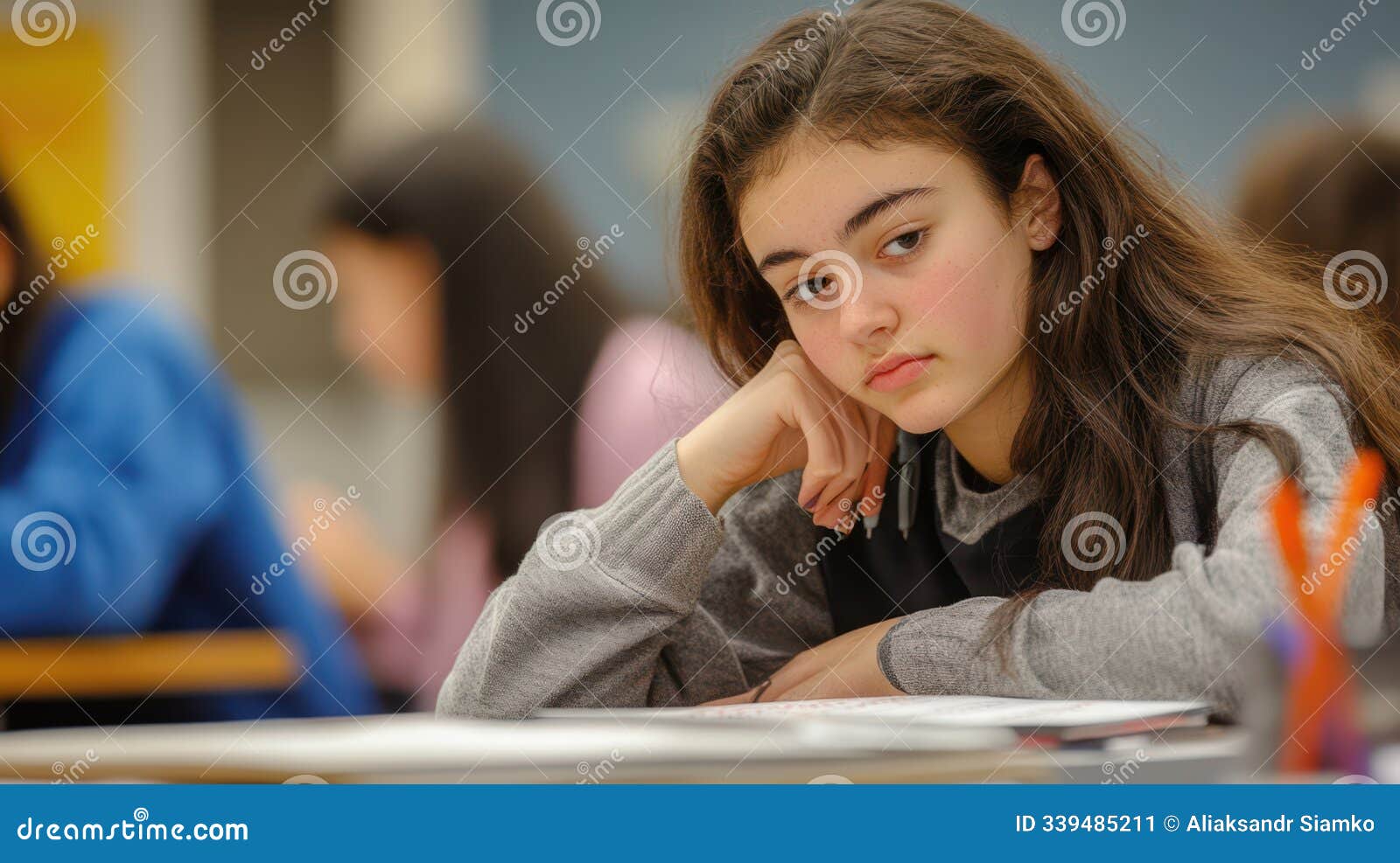 Student Focusing on a Math Problem during a Test in a Classroom Setting ...