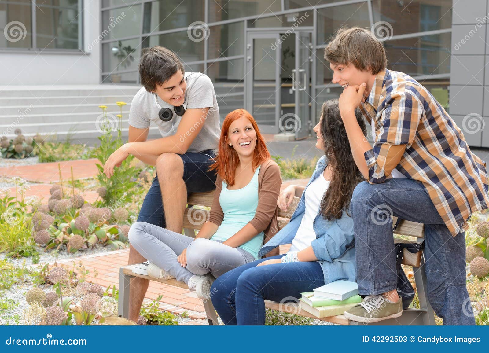 Student Friends Sitting Outside Campus Laughing Stock Image - Image of ...