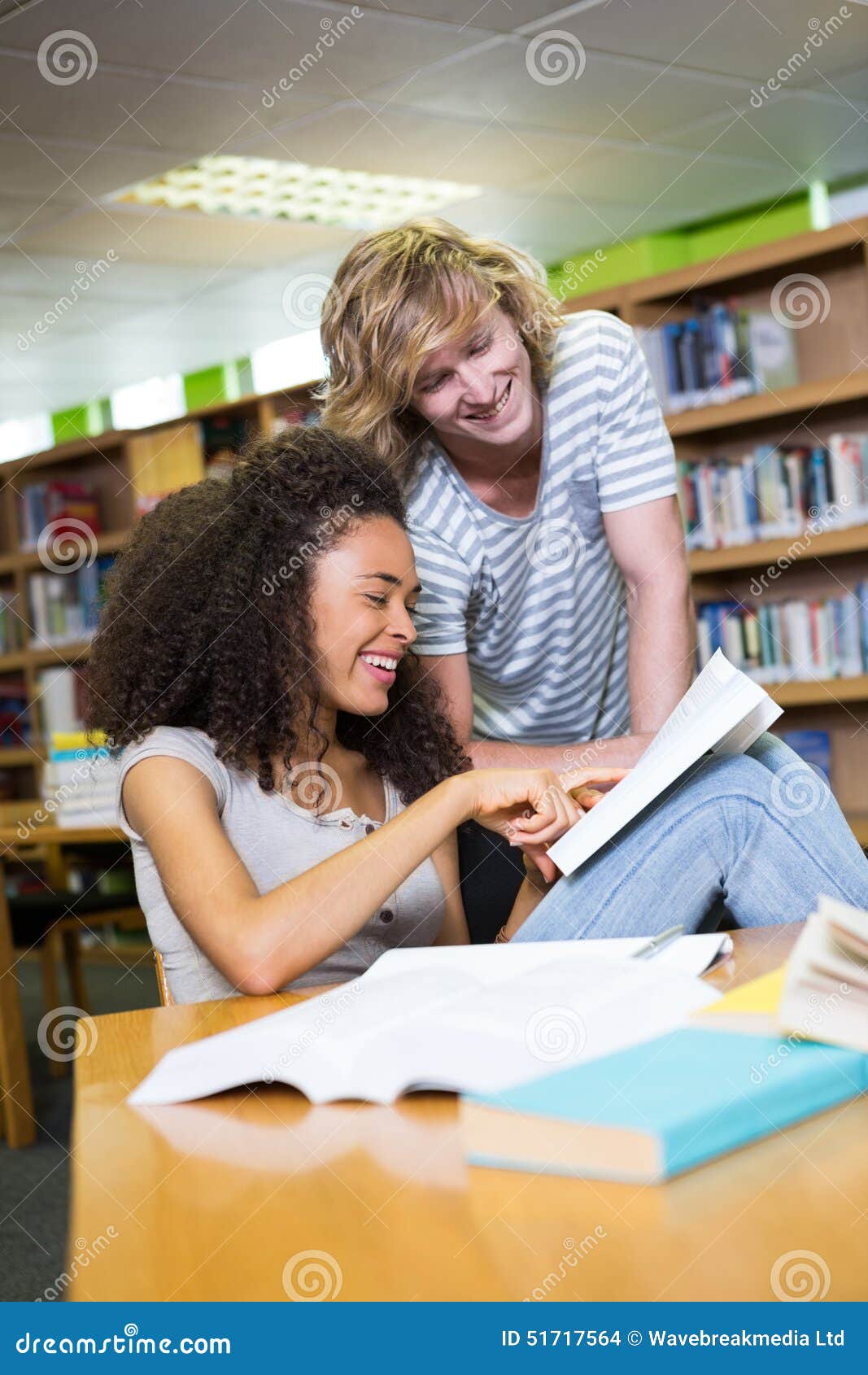 Student Getting Help from Classmate in Library Stock Photo - Image of ...