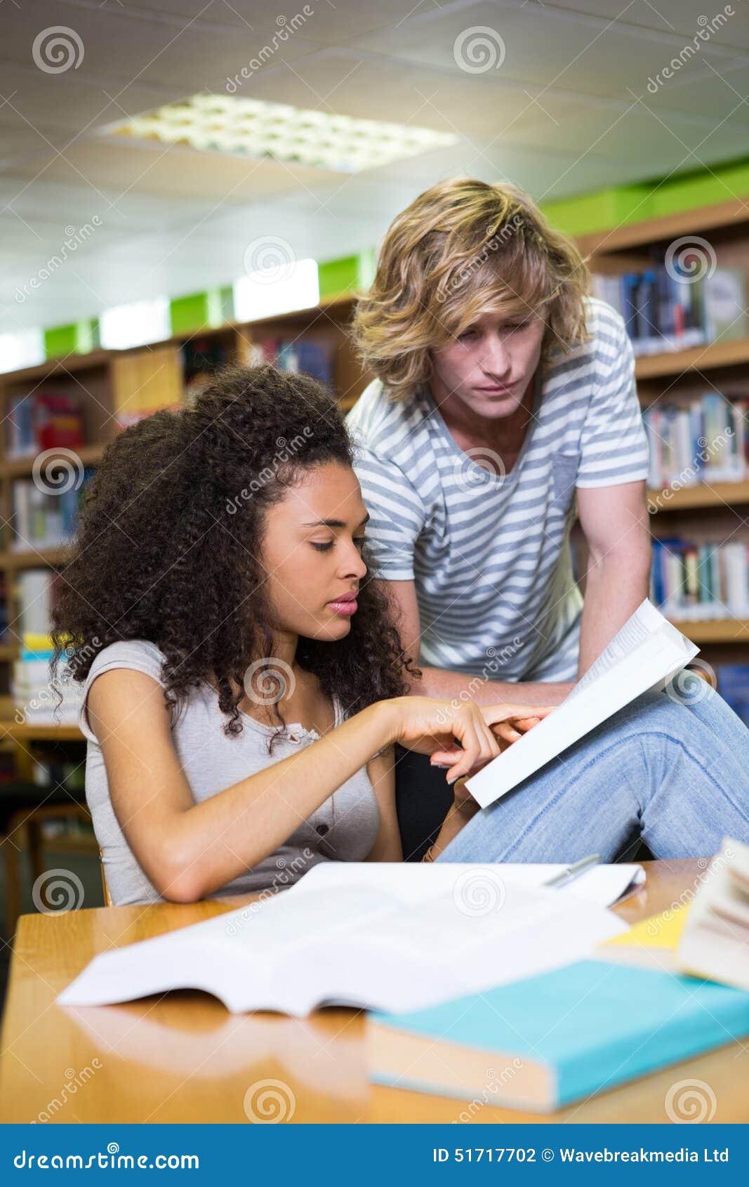 Student Getting Help from Classmate in Library Stock Photo - Image of ...
