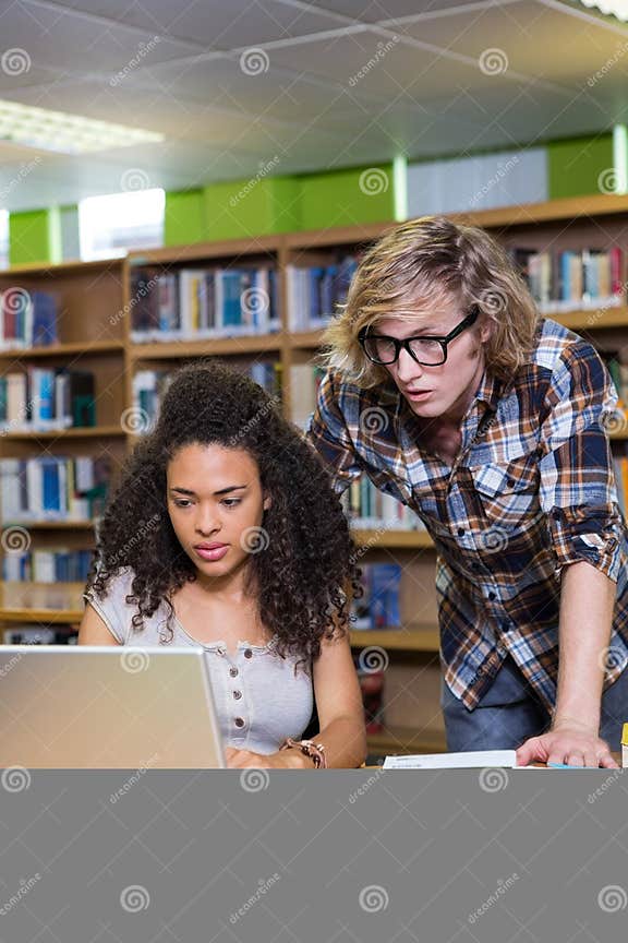 Student Getting Help from Classmate in Library Stock Photo - Image of ...