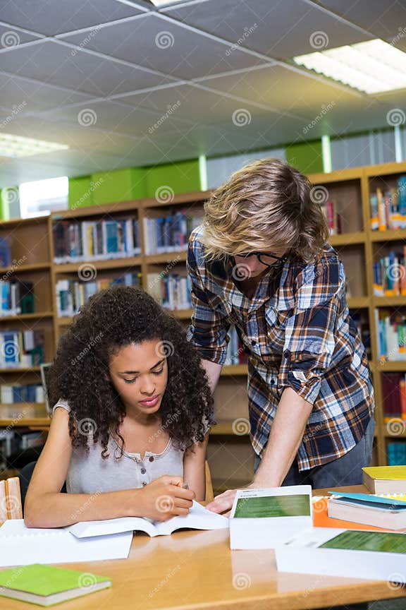 Student Getting Help from Classmate in Library Stock Image - Image of ...
