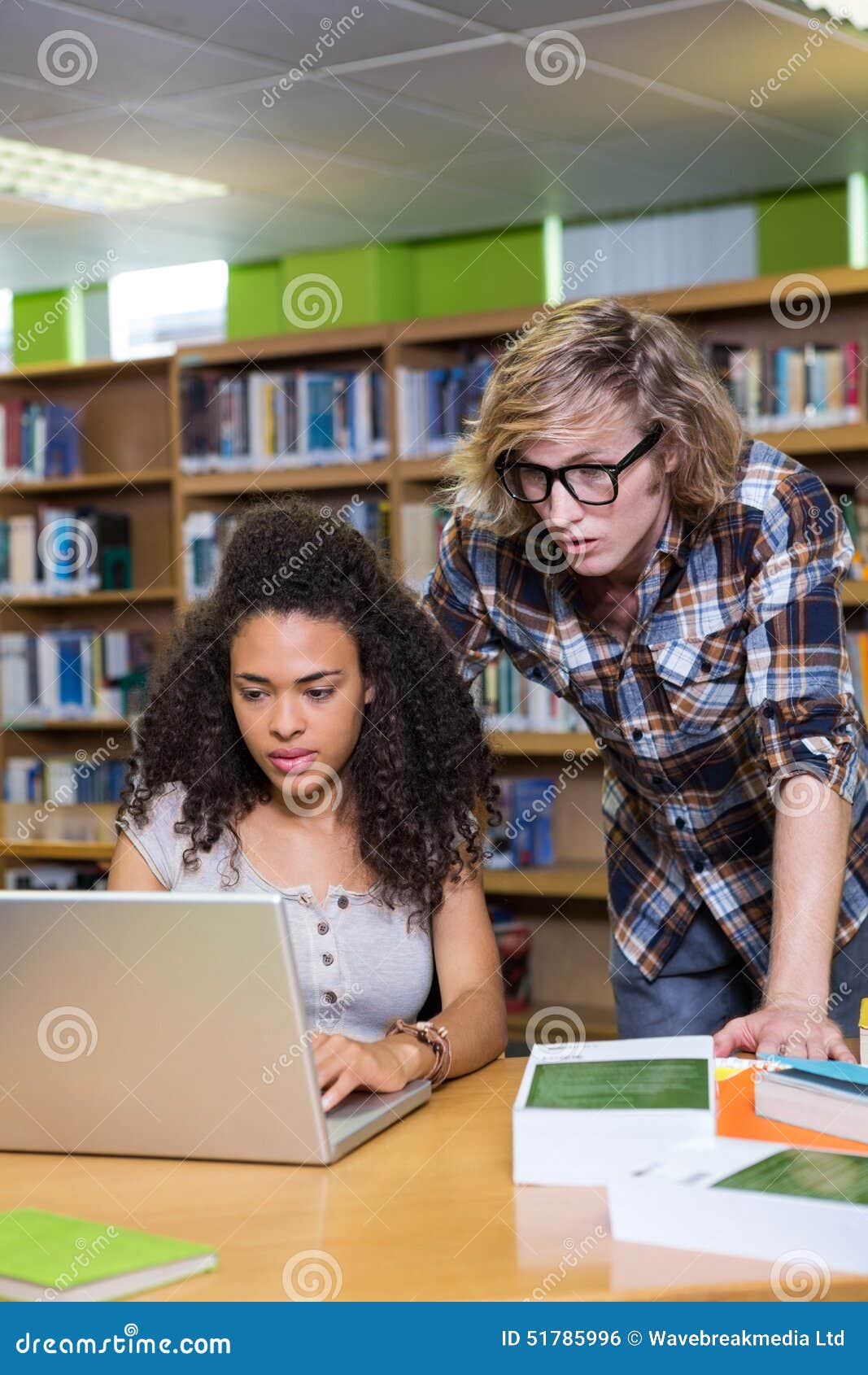 Student Getting Help from Classmate in Library Stock Photo - Image of ...