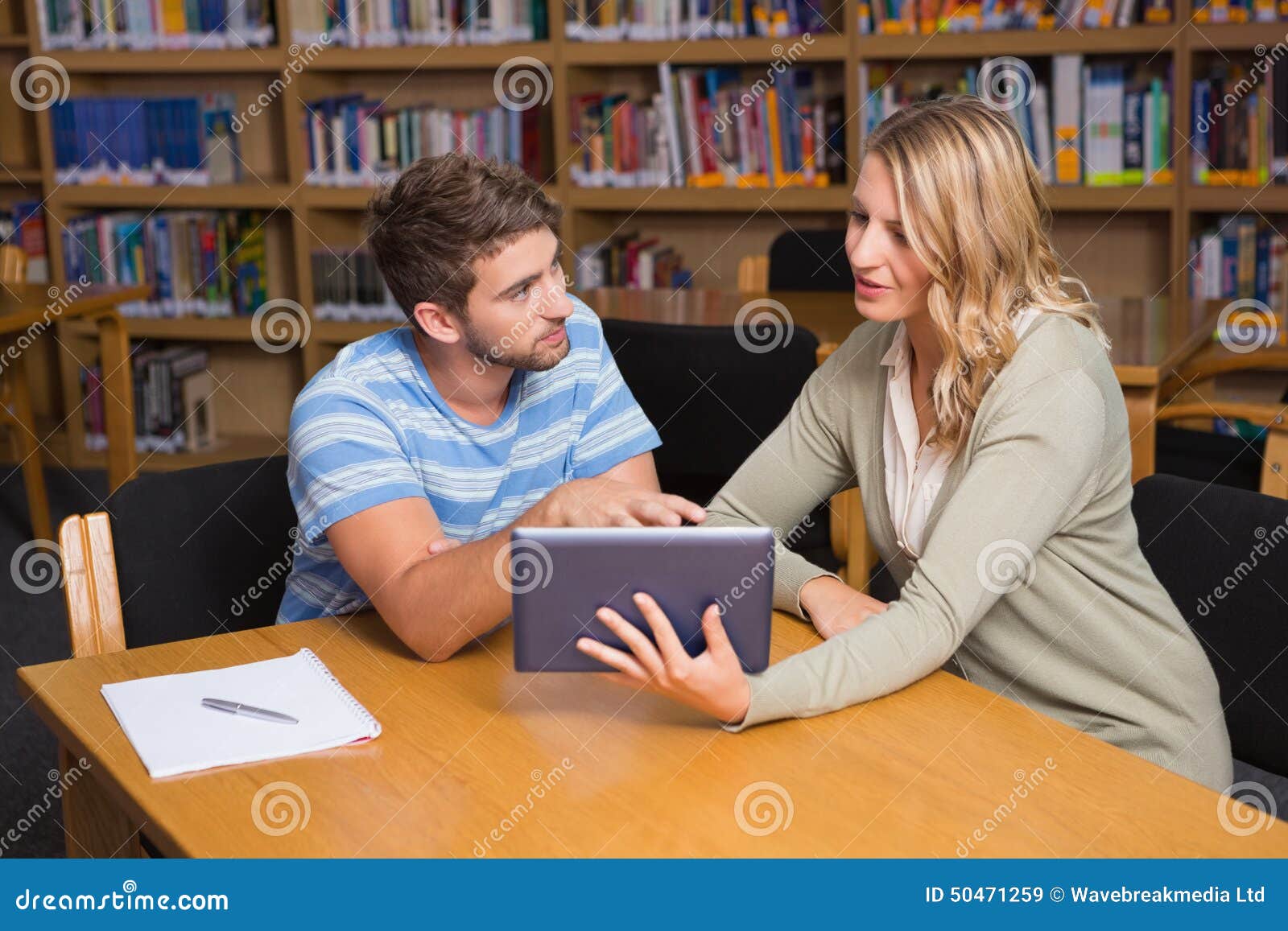 Student Getting Help from Tutor in Library Stock Image - Image of ...