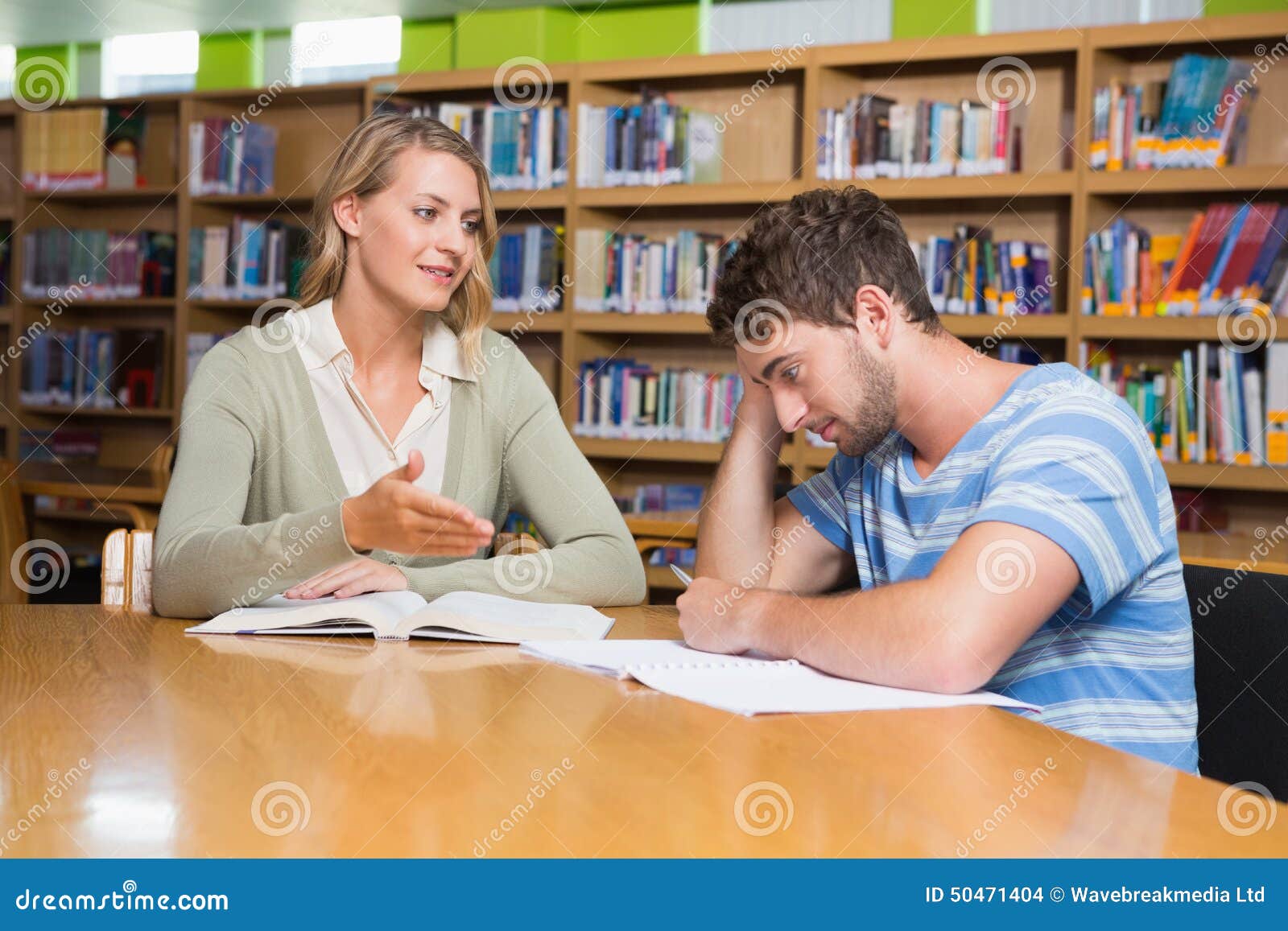 Student Getting Help from Tutor in Library Stock Photo - Image of book ...