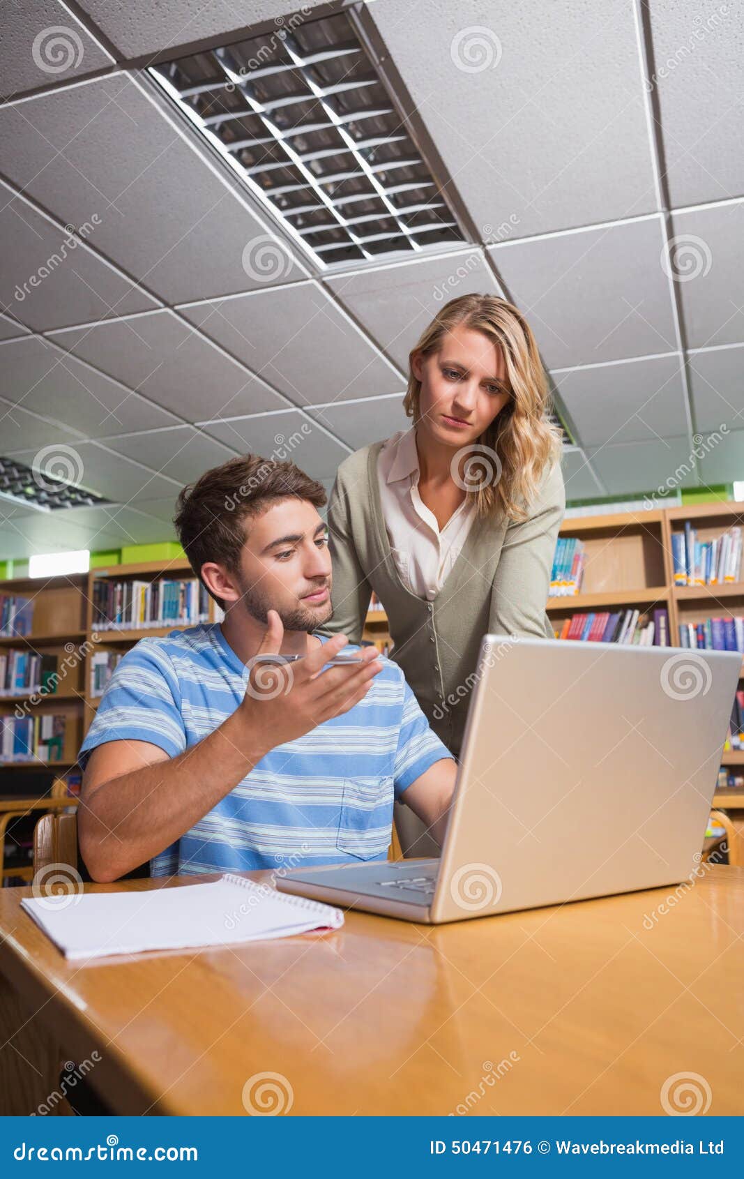 Student Getting Help from Tutor in Library Stock Photo - Image of ...