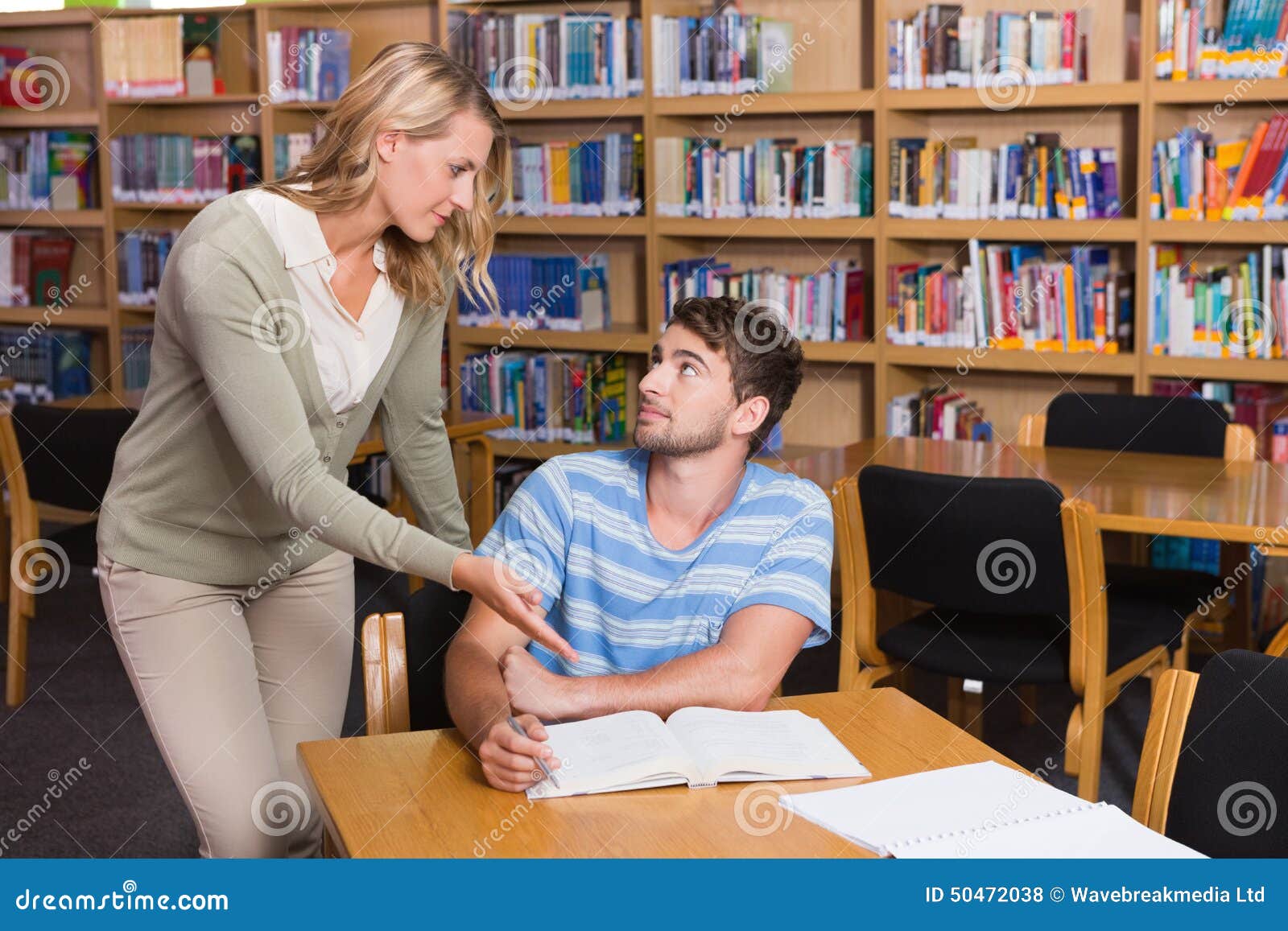 Student Getting Help from Tutor in Library Stock Photo - Image of ...