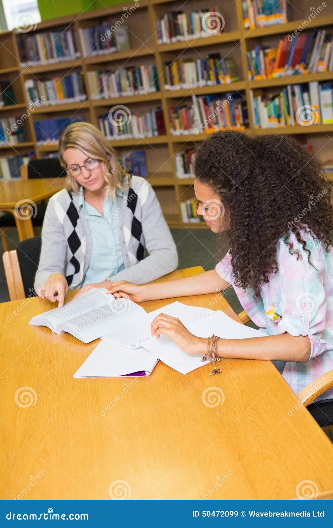 Student Getting Help from Tutor in Library Stock Image - Image of ...