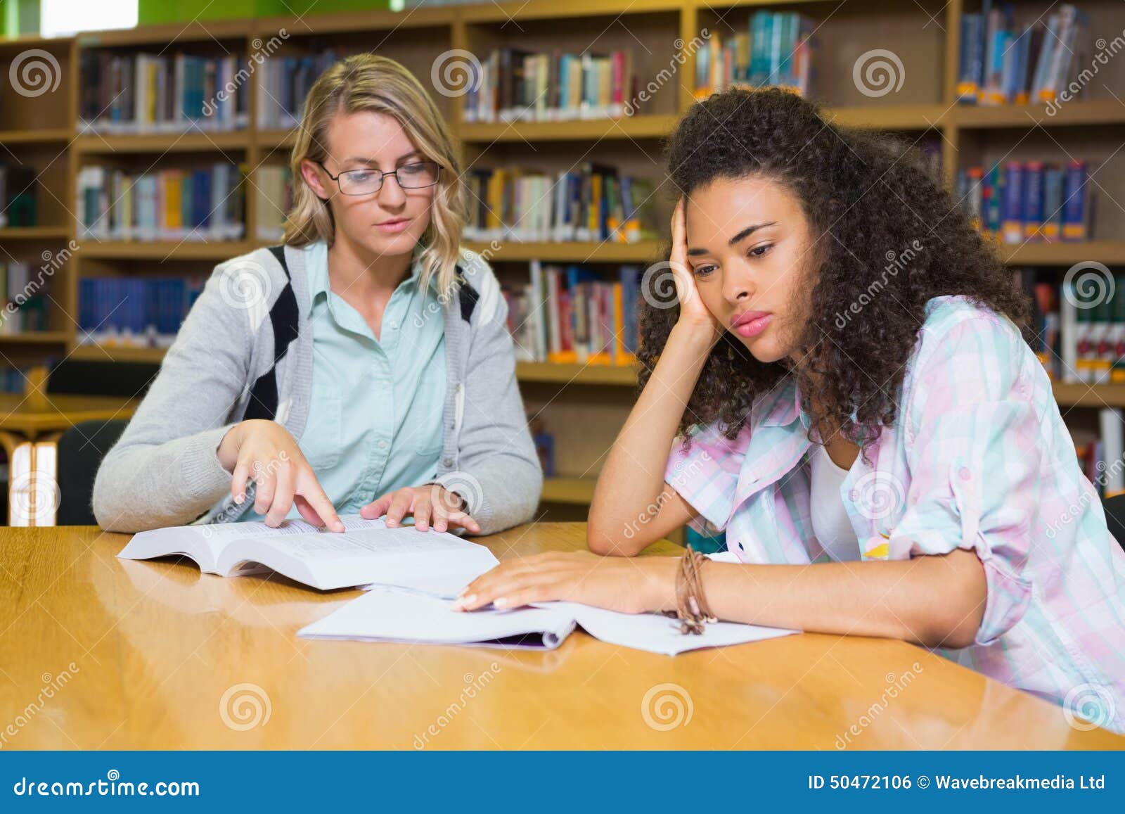Student Getting Help from Tutor in Library Stock Photo - Image of ...