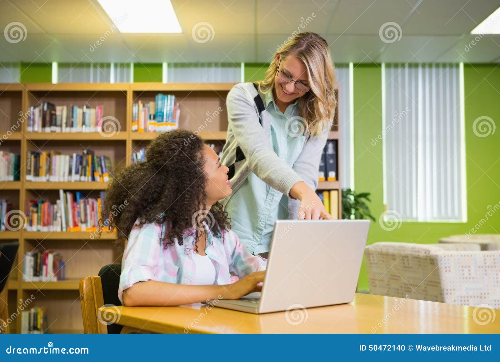Student Getting Help from Tutor in Library Stock Photo - Image of desk ...
