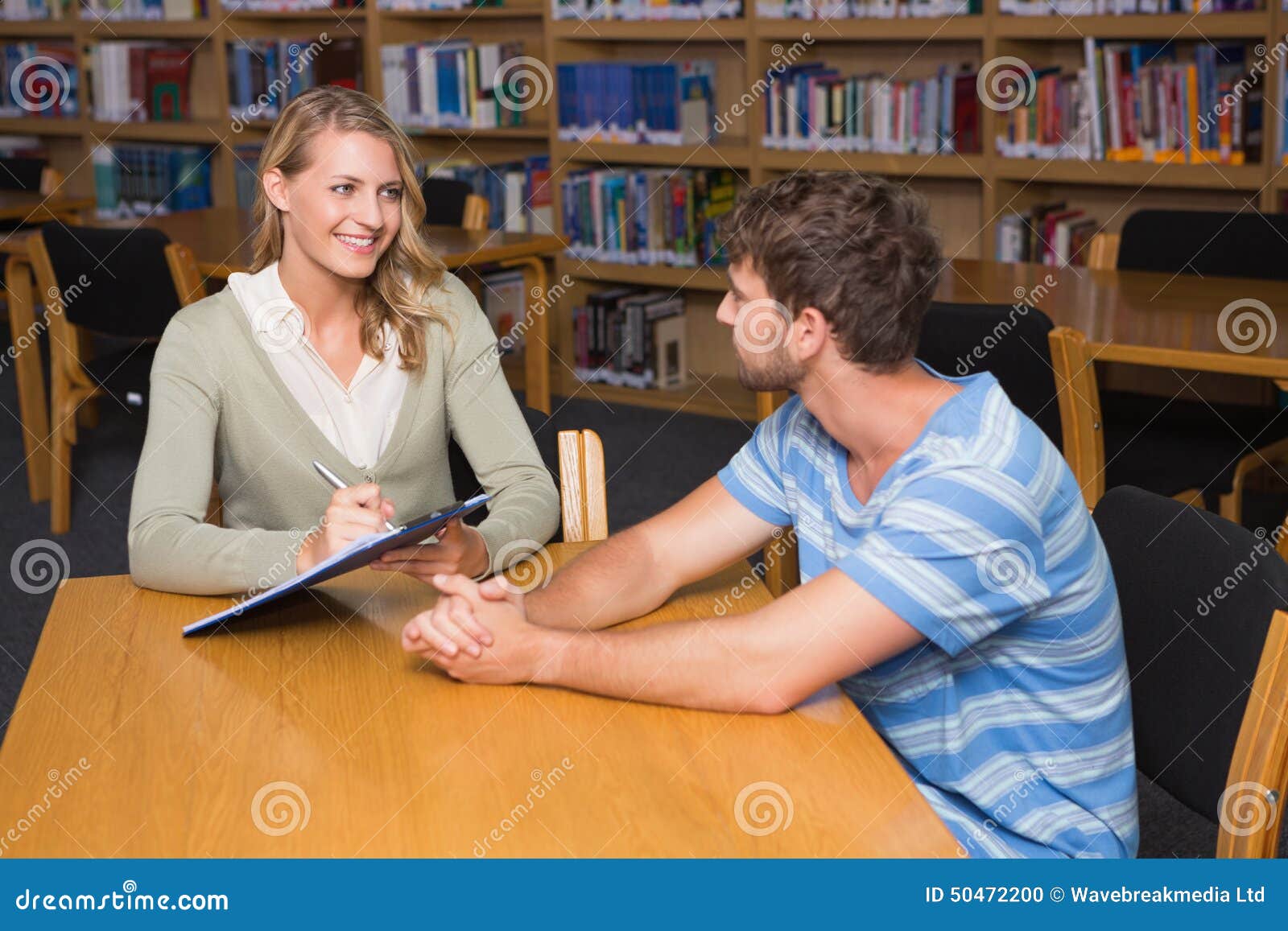 Student Getting Help from Tutor in Library Stock Photo - Image of ...