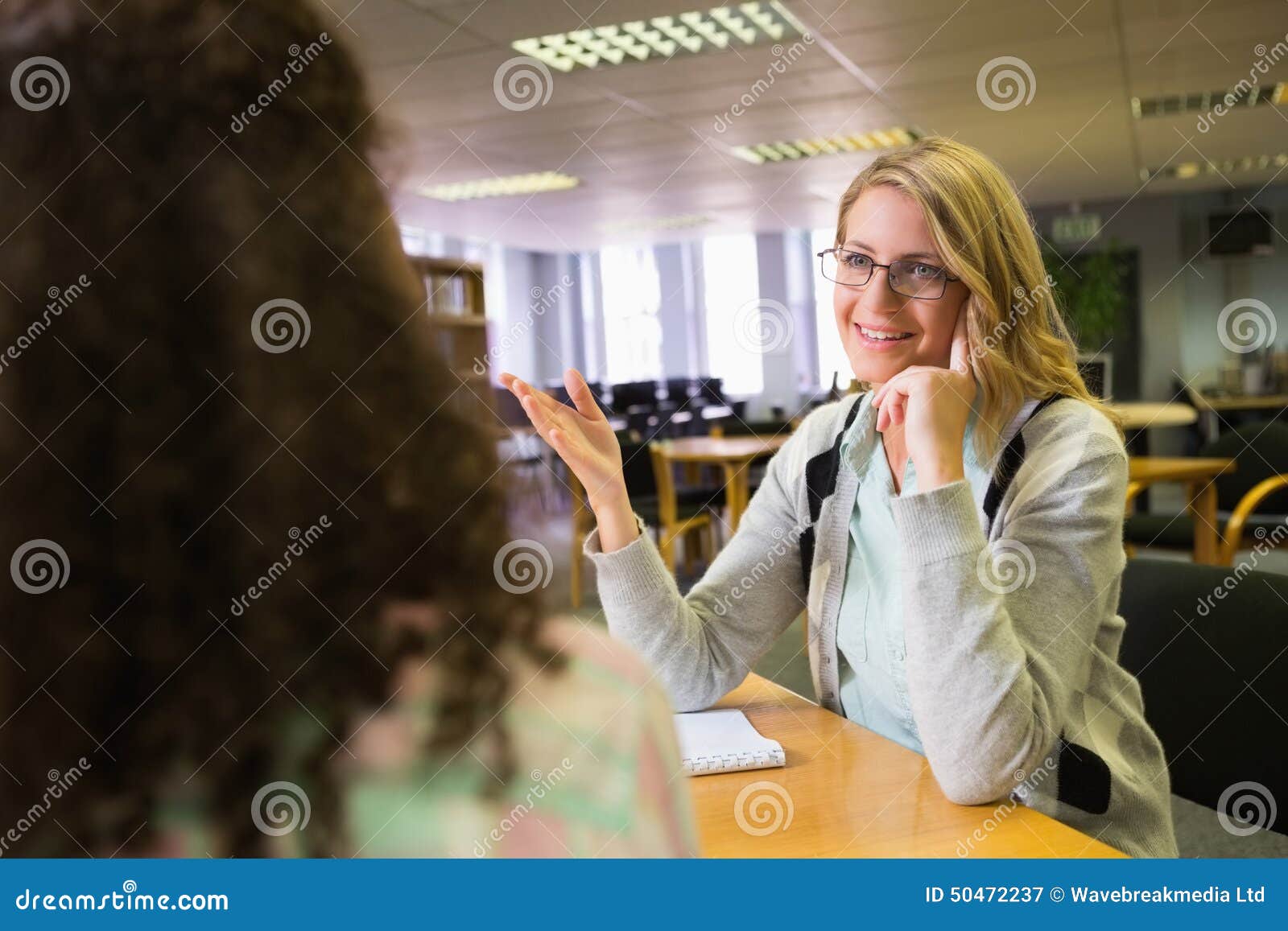 Student Getting Help from Tutor in Library Stock Image - Image of ...
