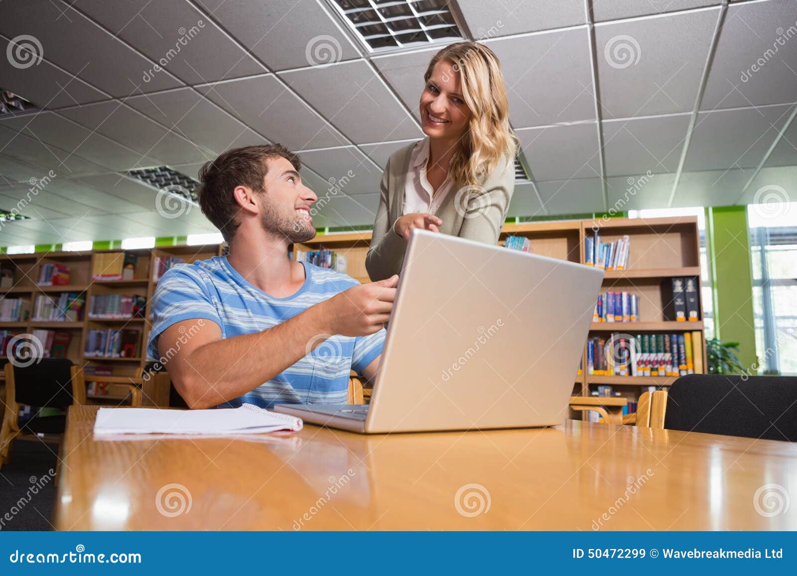 Student Getting Help from Tutor in Library Stock Image - Image of adult ...