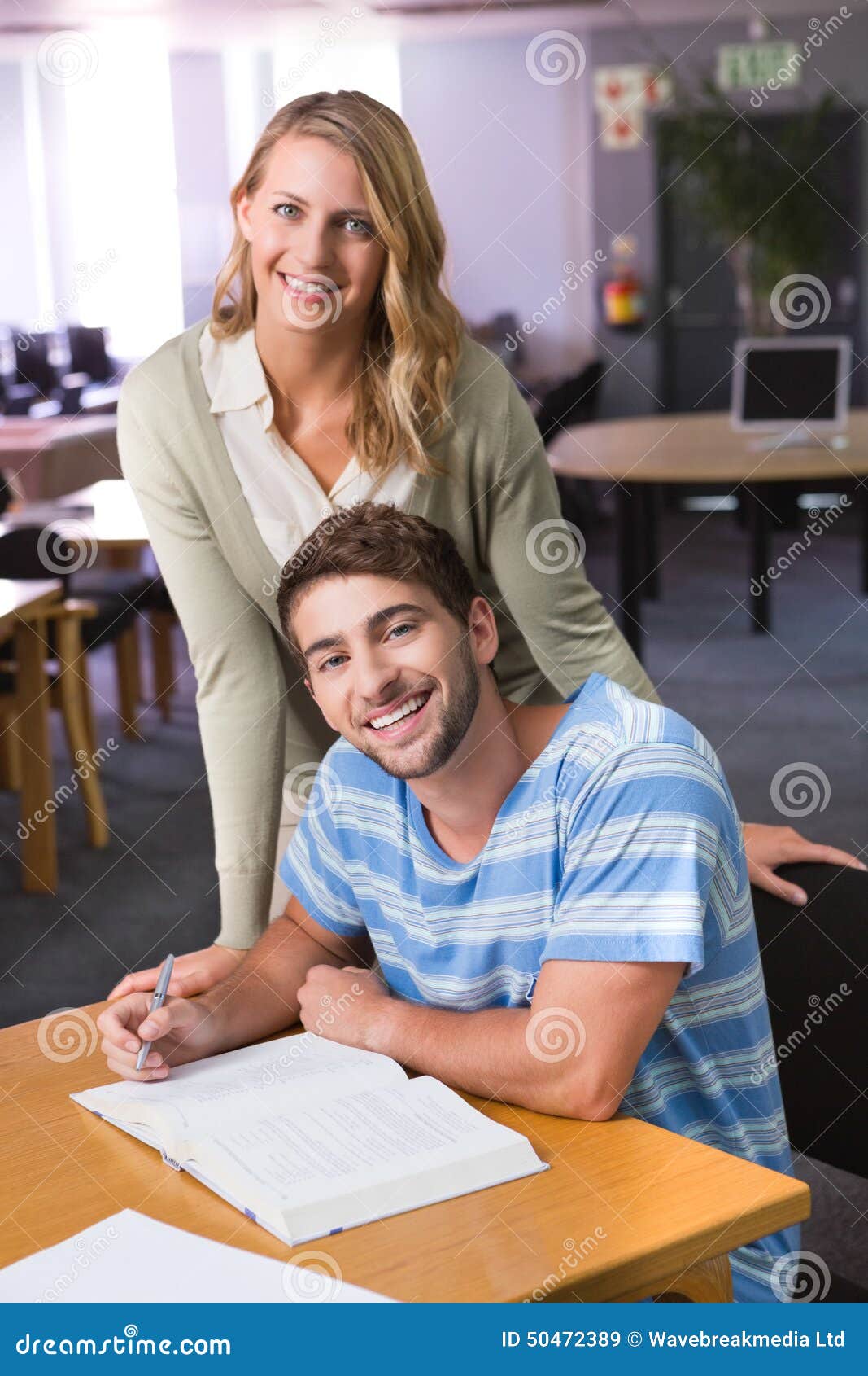 Student Getting Help from Tutor in Library Stock Image - Image of ...