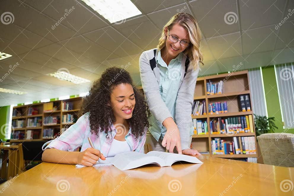 Student Getting Help from Tutor in Library Stock Image - Image of ...