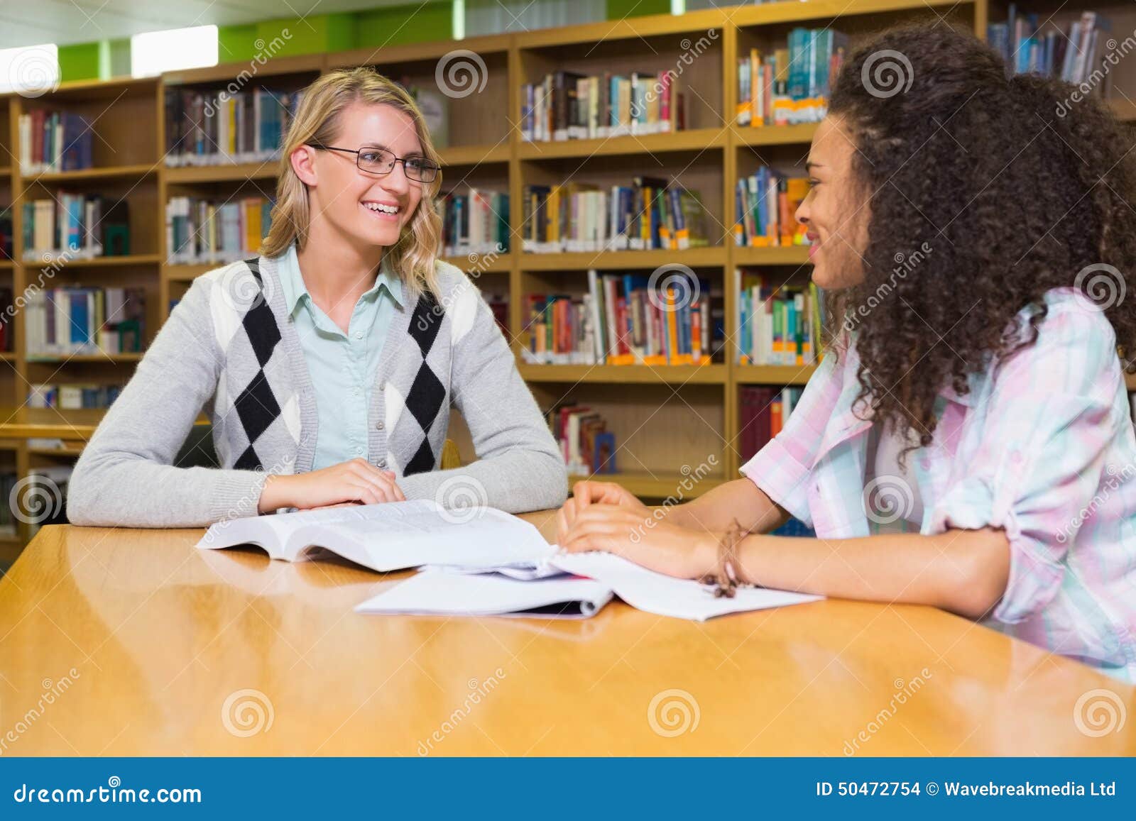 Student Getting Help from Tutor in Library Stock Photo - Image of ...