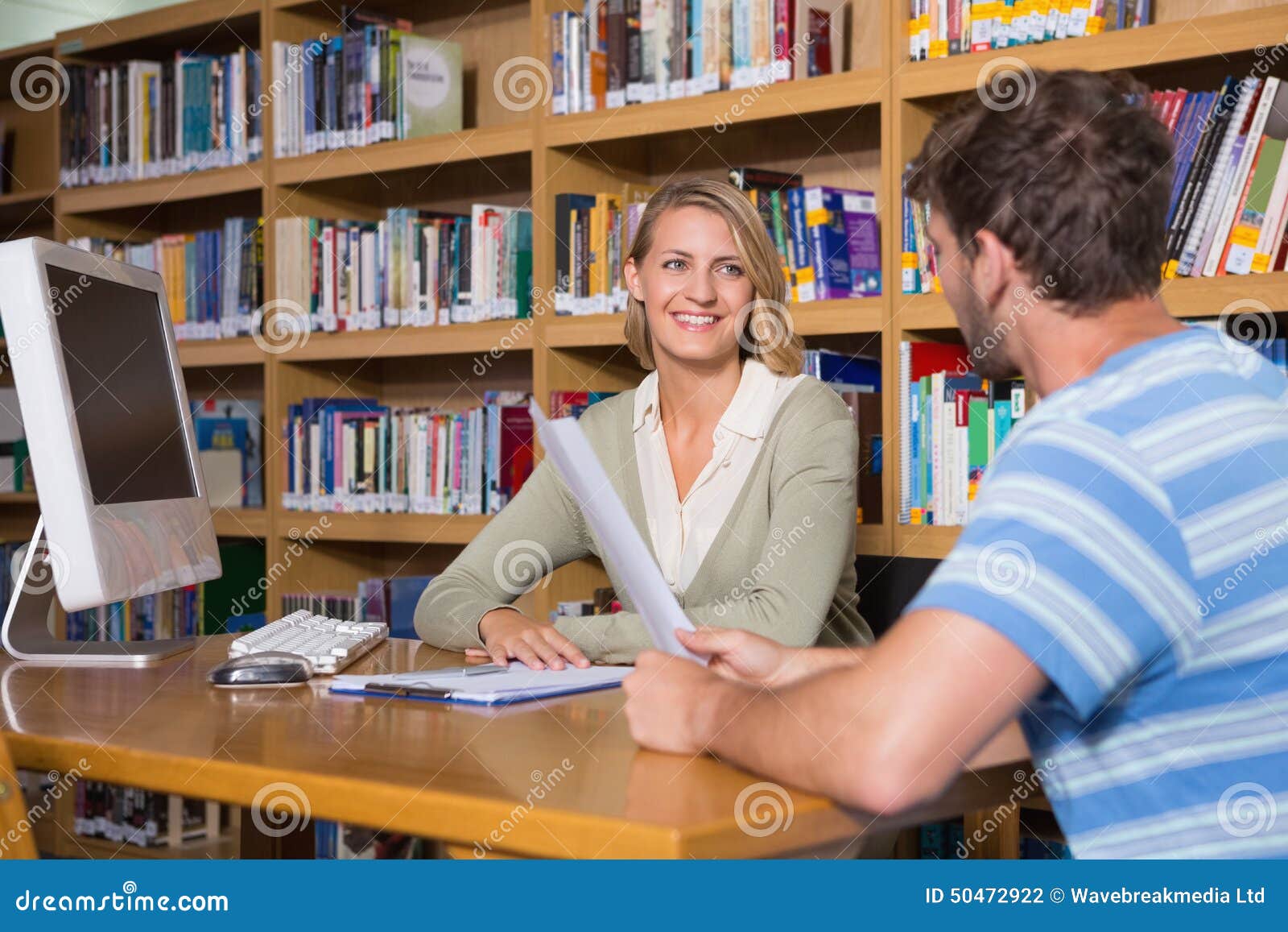 Student Getting Help from Tutor in Library Stock Photo - Image of happy ...