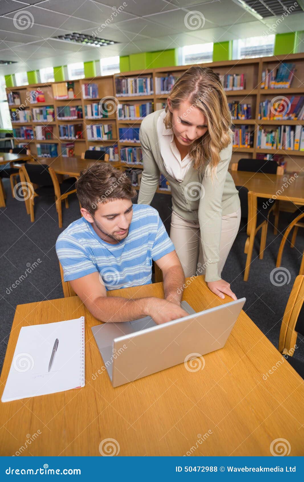 Student Getting Help from Tutor in Library Stock Photo - Image of ...