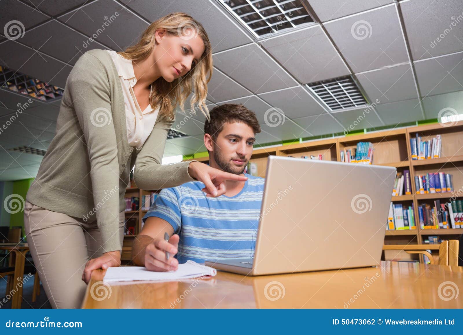 Student Getting Help from Tutor in Library Stock Photo - Image of ...