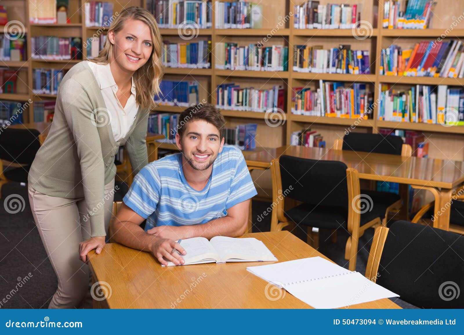 Student Getting Help from Tutor in Library Stock Photo - Image of ...