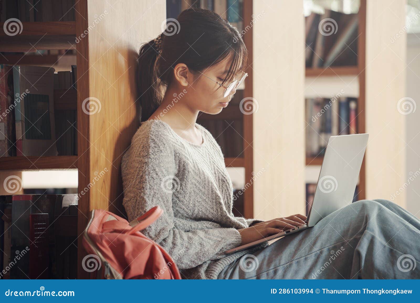 Student Girl Sitting on Floor and Using Laptop, Writes Notes for Paper ...