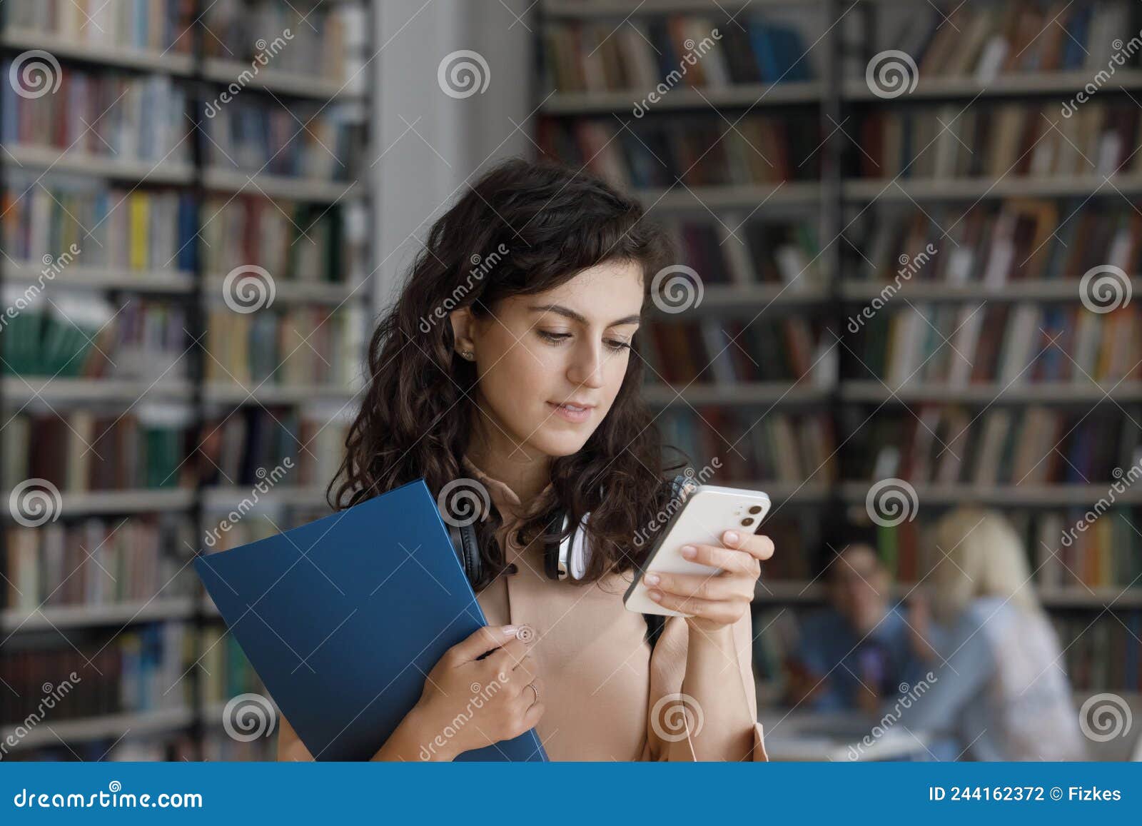 Student Girl Using Smartphone Standing in Library Stock Photo - Image ...