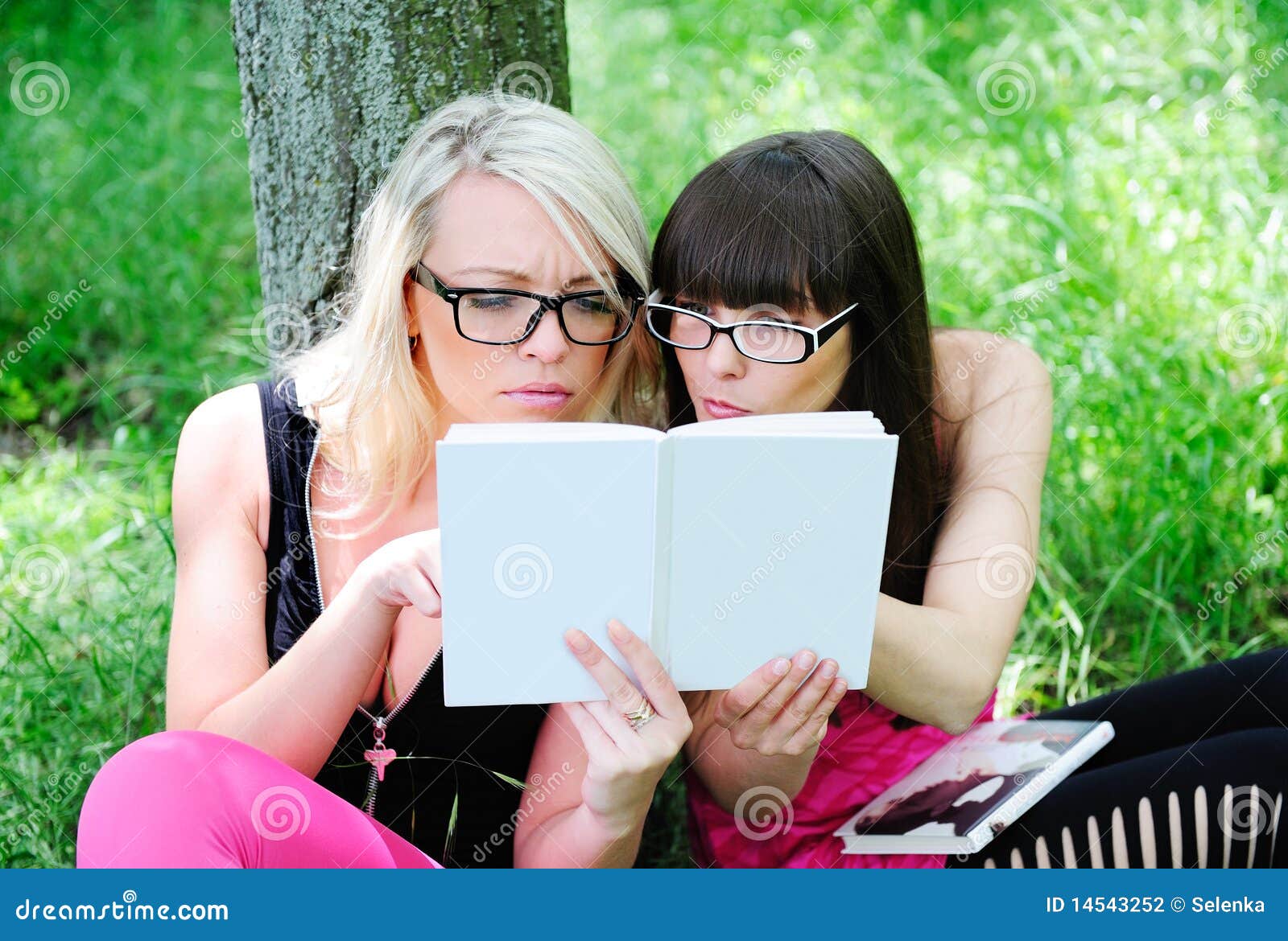 Student Girls Reading the Book Stock Photo - Image of grass, emotional ...