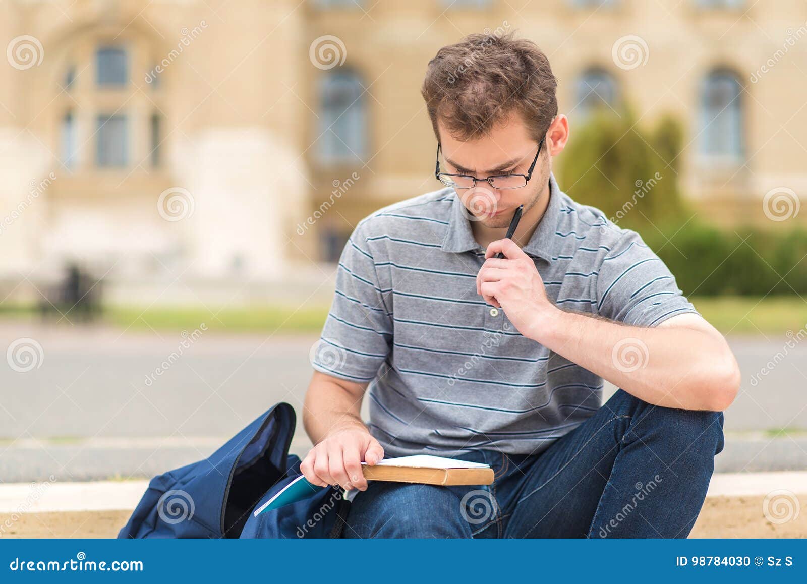 Student guy doing homework stock photo. Image of person - 98784030