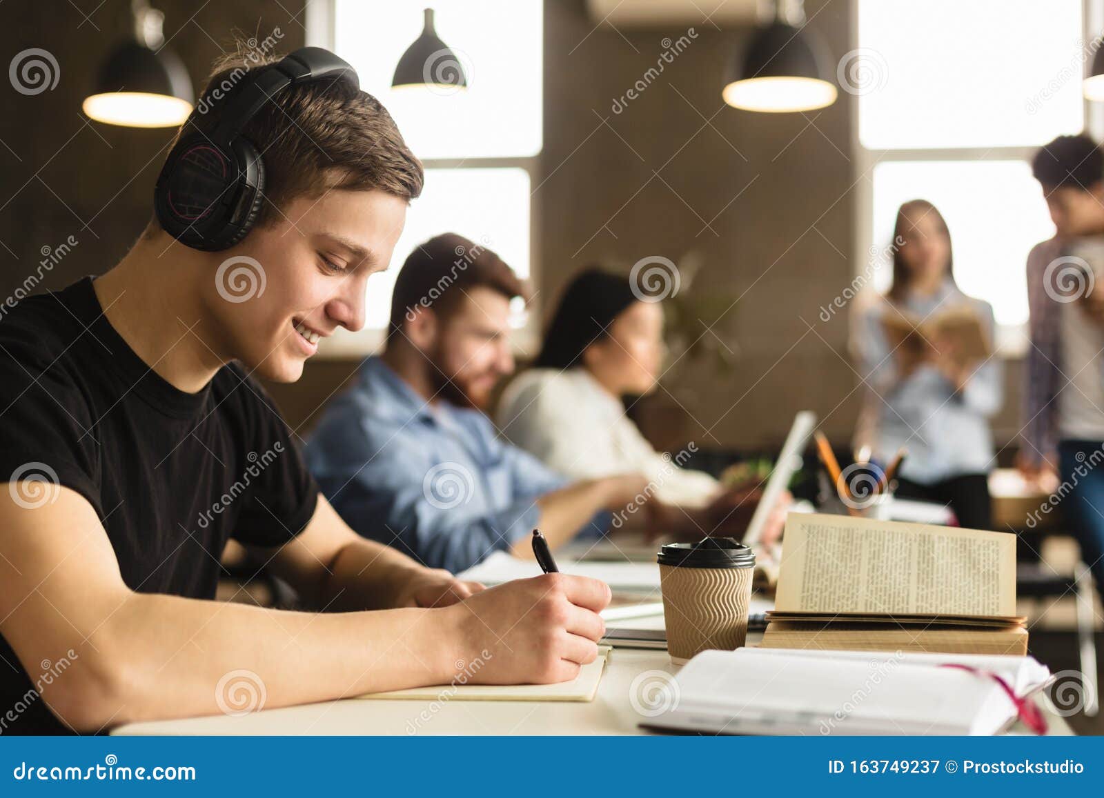 Student Guy Preparing for Classes, Taking Notes in Library Stock Image ...