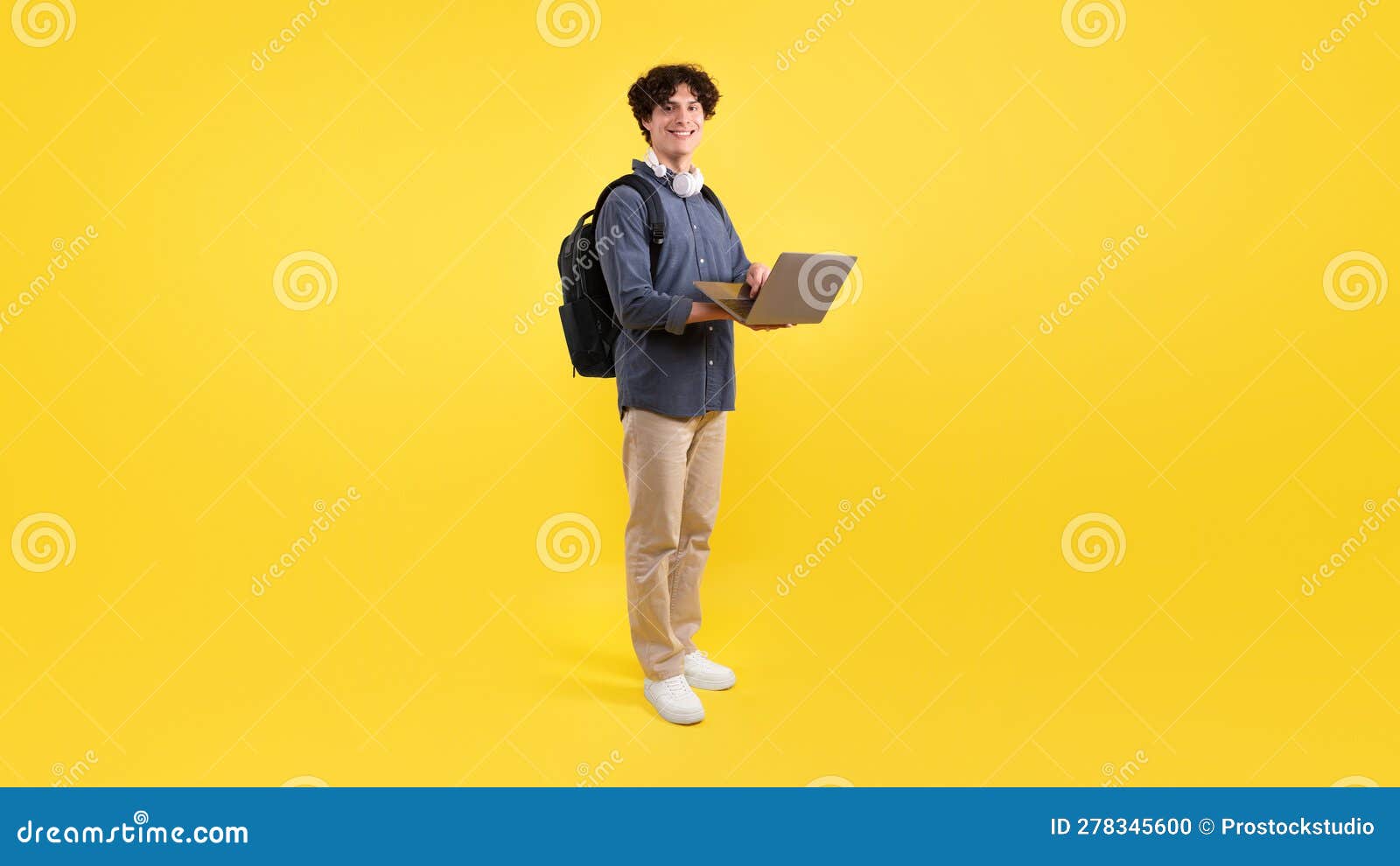 Student Guy Using Laptop Standing with Backpack Over Yellow Background ...