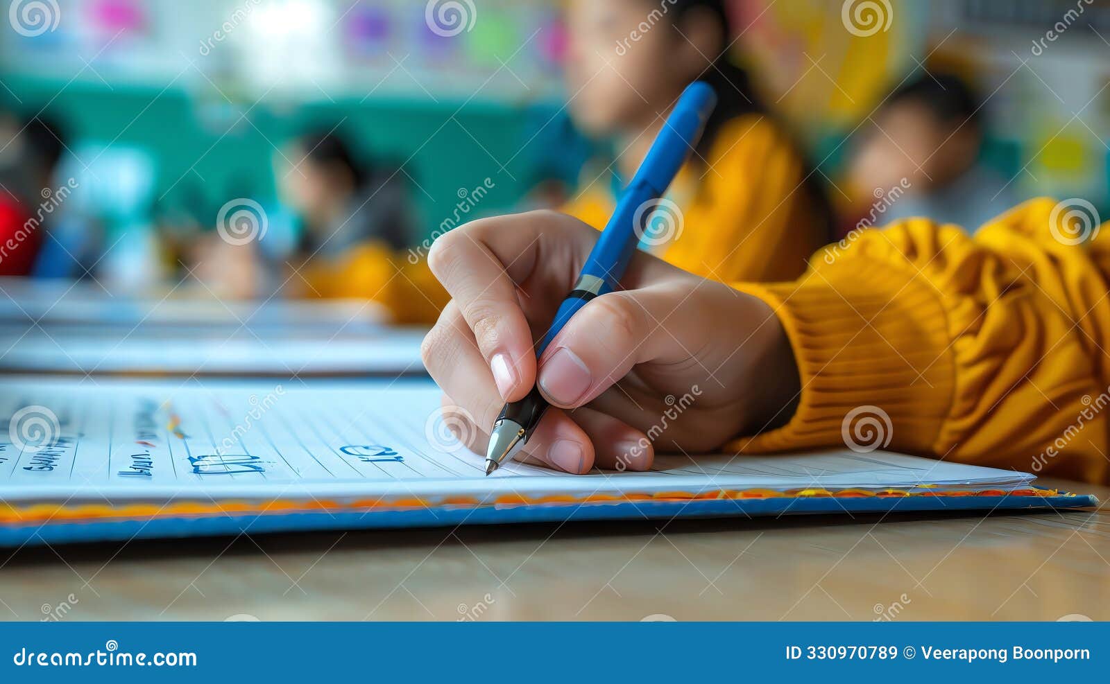 Student Hand with Pen in Notebook, Clear Classroom Background Stock ...