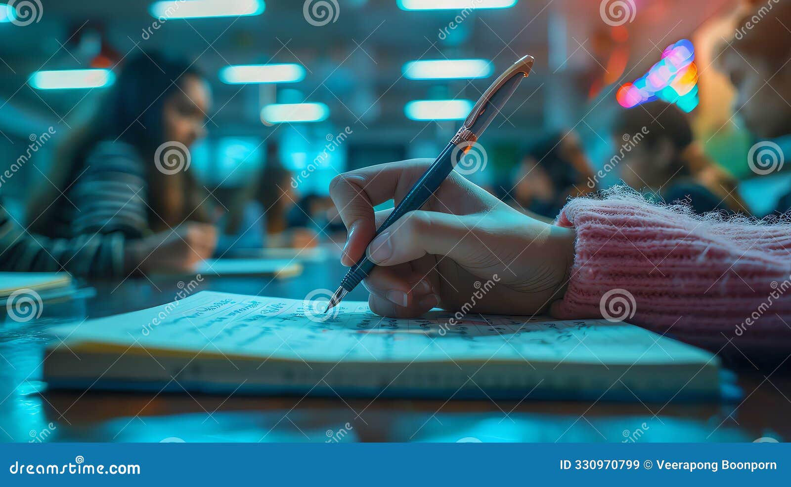 Student Hand with Pen in Notebook, Clear Classroom Background Stock ...