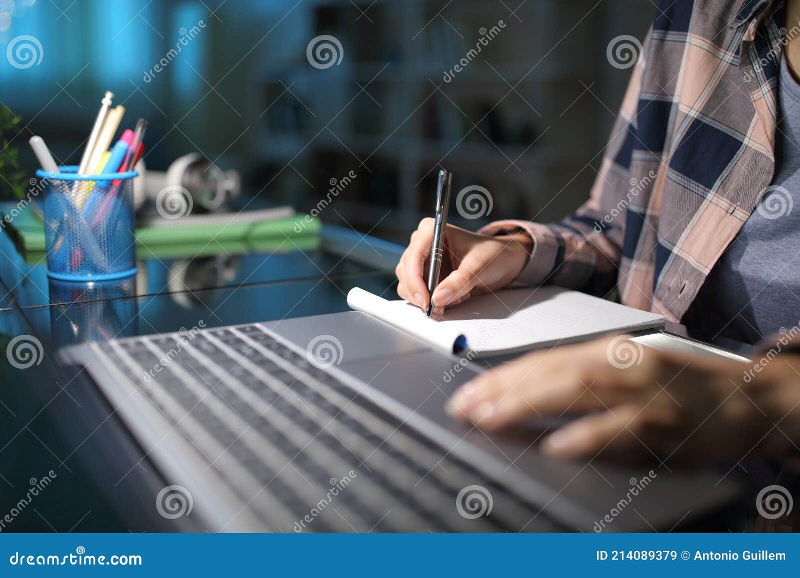 Student Hand Taking Notes Checking Laptop in the Night Stock Image ...