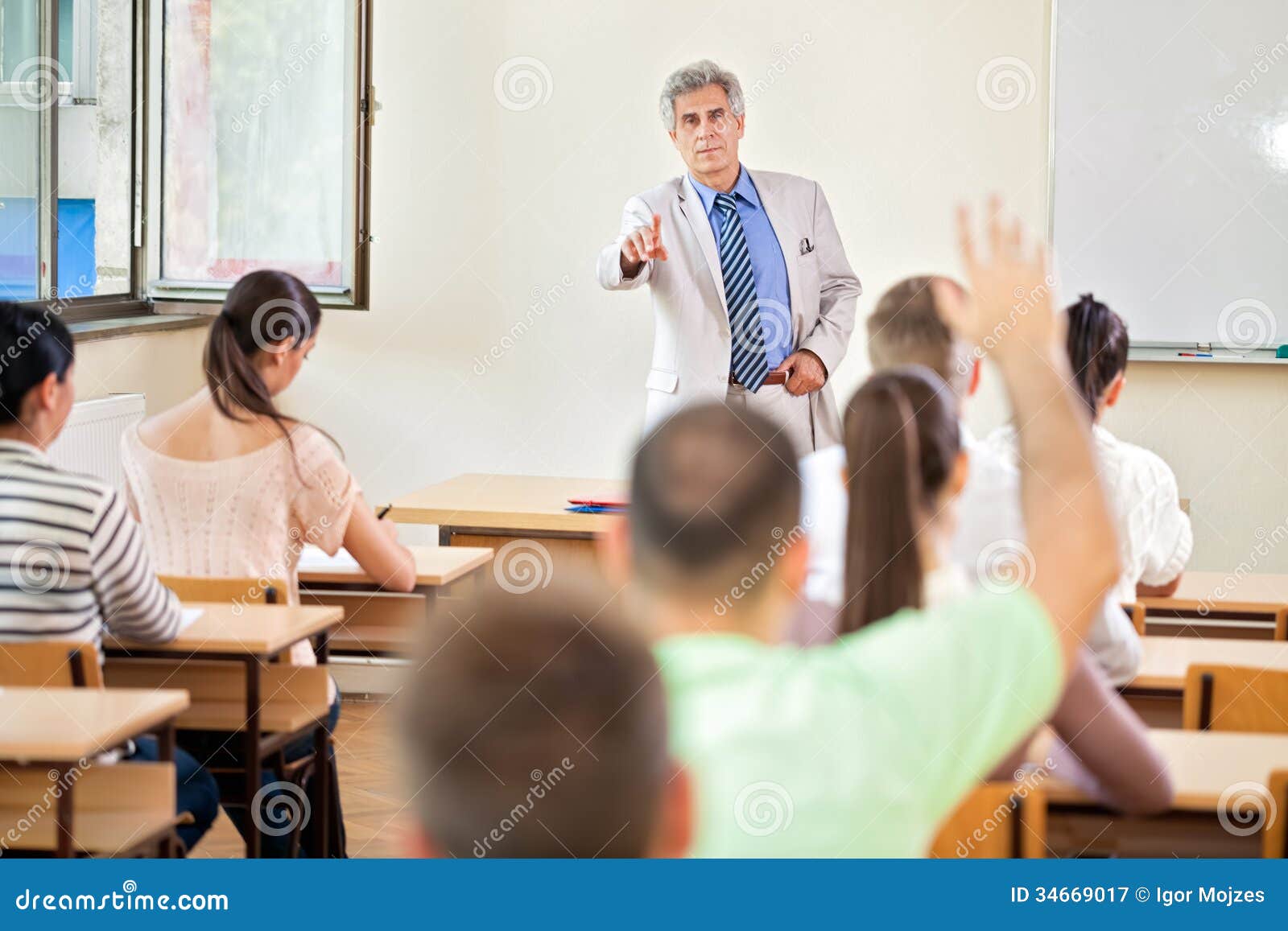 Student with Hand Up in Class Stock Image - Image of male, pointing ...