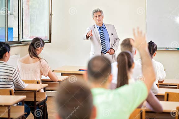 Student with Hand Up in Class Stock Image - Image of male, pointing ...