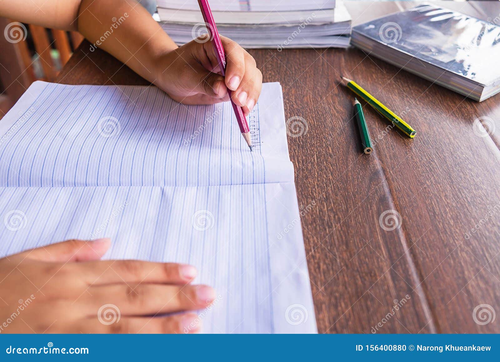 The Student`s Hand is Written on Paper on the School Table Stock Photo ...