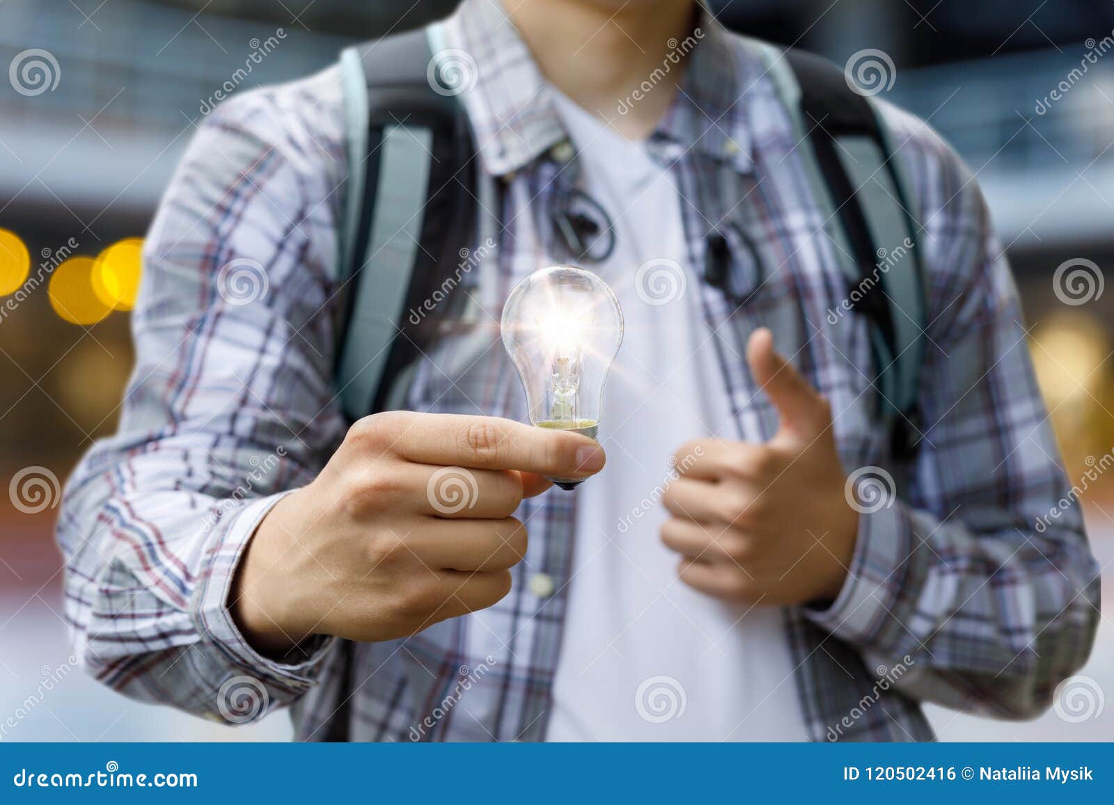 A Student Holding a Burning Light Bulb. Stock Photo - Image of person ...