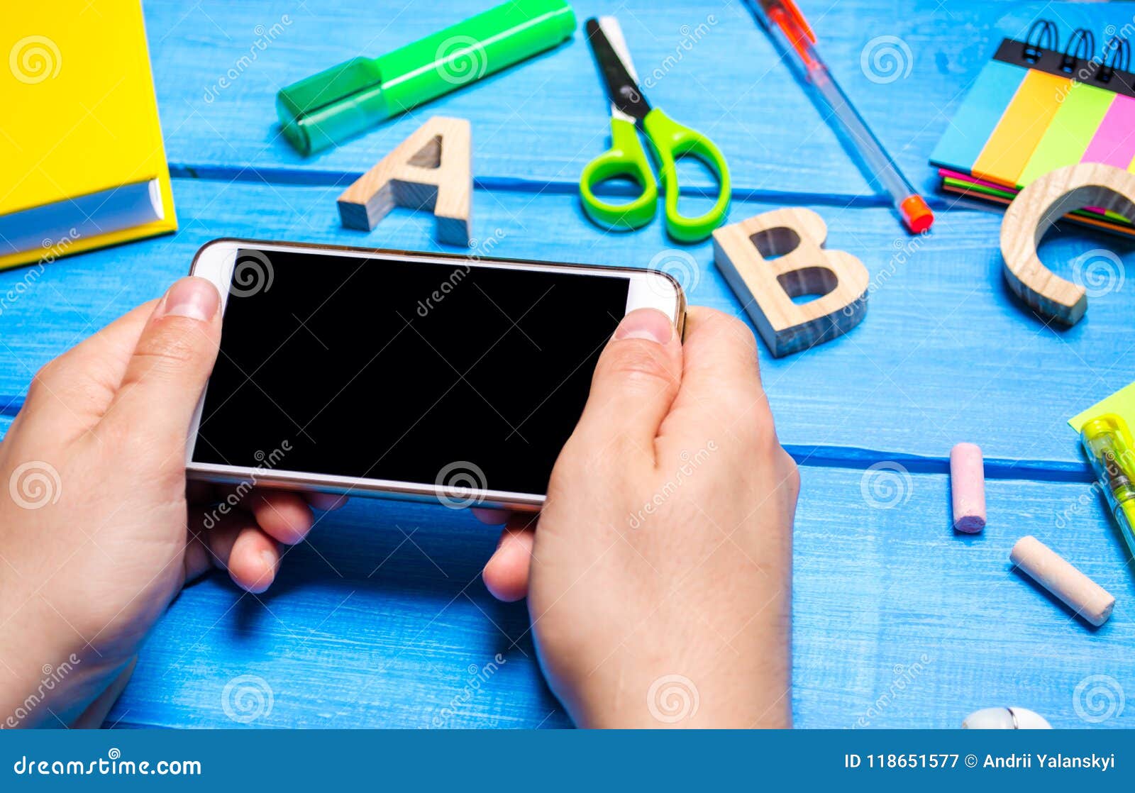 The Student is Holding a Mobile Phone in the Background of a Creative ...
