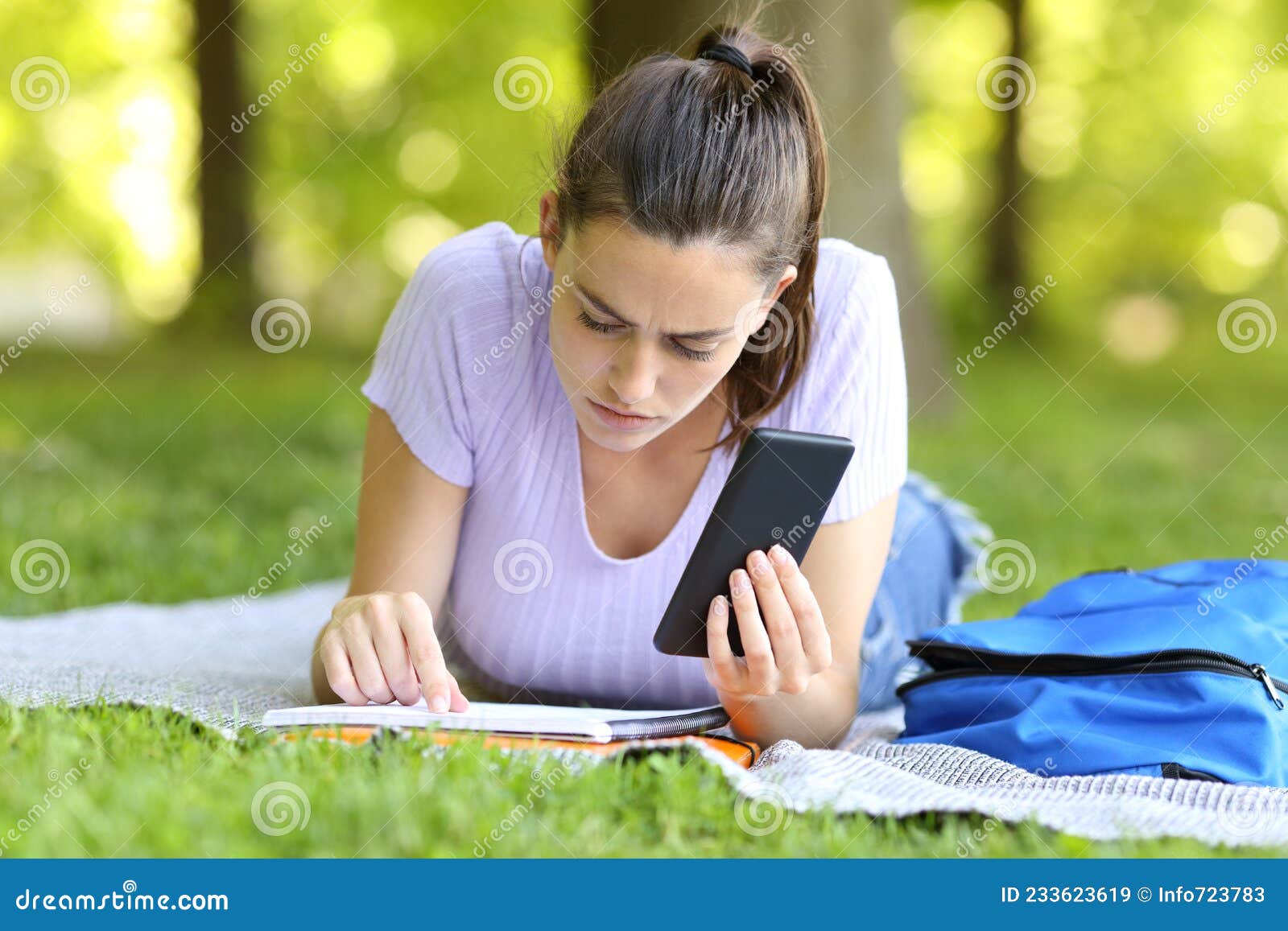 Student Holding Phone Checking Notes Studying in a Campus Stock Image ...