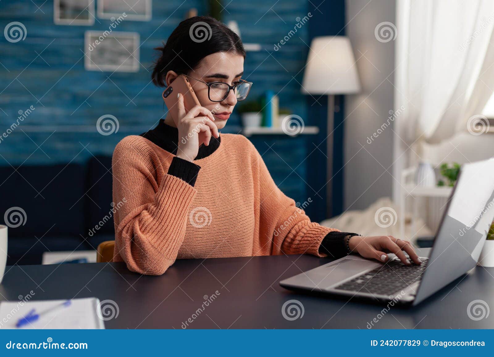 Student at Home Talking on the Phone while Using Laptop. Stock Image ...
