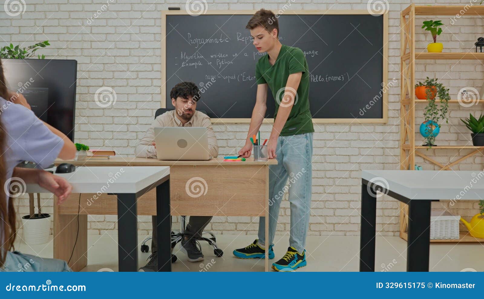 Student and Instructor Discuss Python Code in Modern Classroom Stock ...