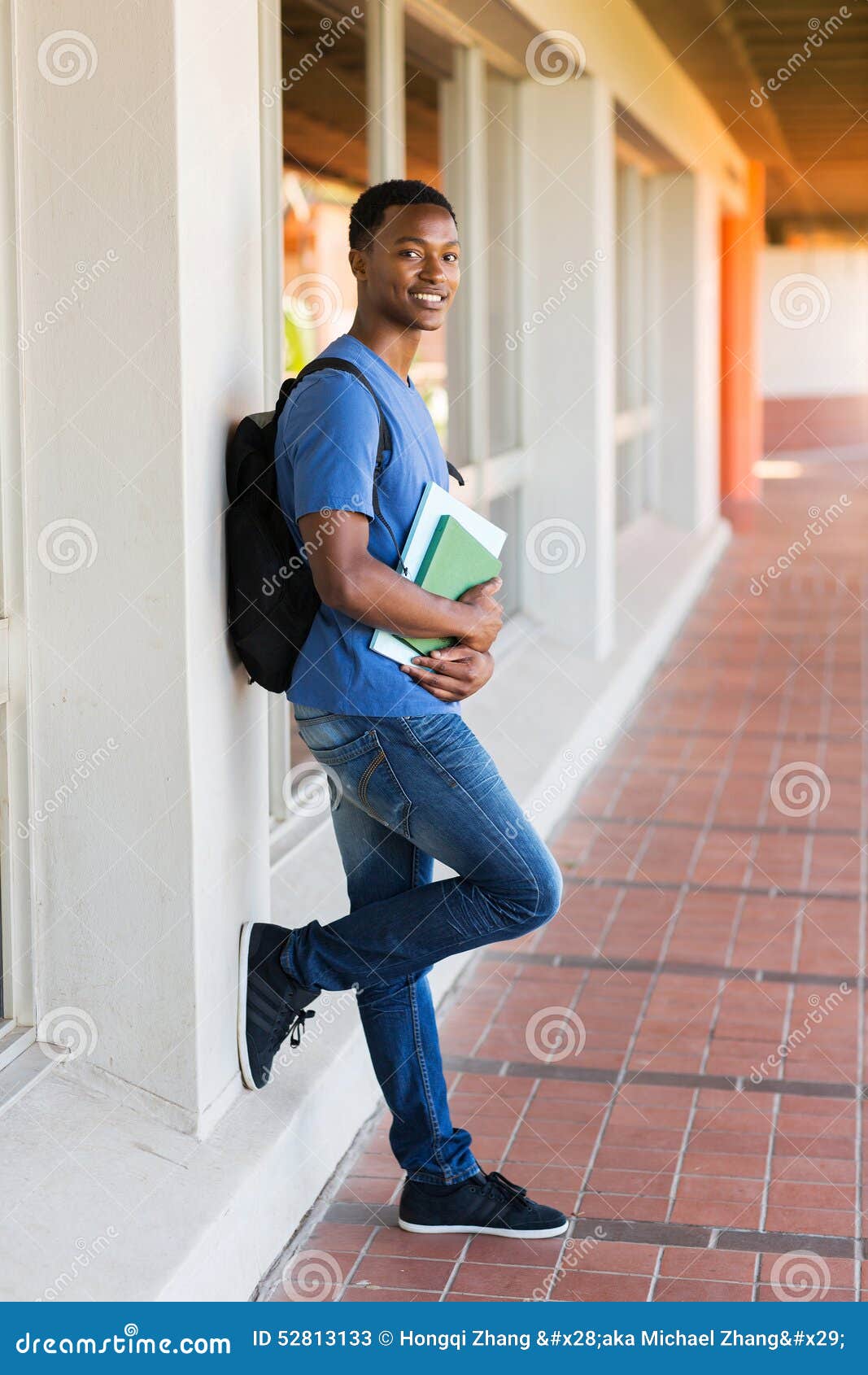 Student Leaning Against Wall Stock Image - Image of college, american ...