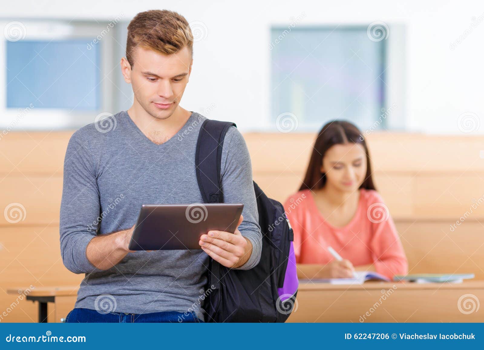 Student Leaning on the Desk and Using Tablet Stock Photo - Image of ...